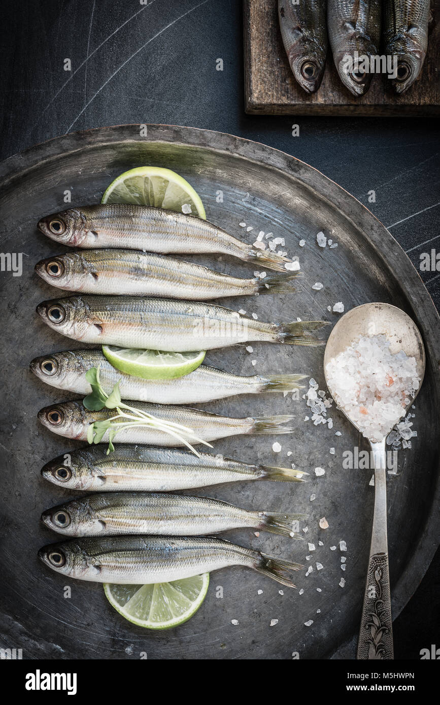 Small raw fish plated Stock Photo - Alamy