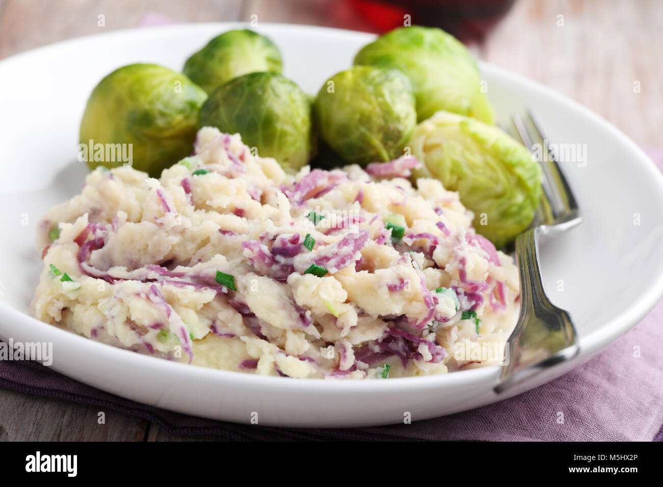 Traditional Dutch dish Stamppot with mashed potato, red cabbage, green ...