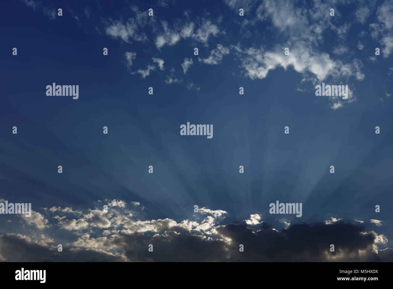 Cloudscape with sun rays coming through the cloud Stock Photo - Alamy