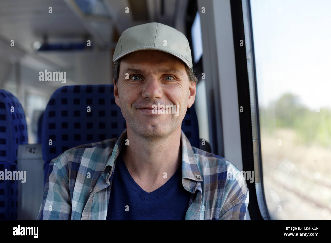 Happy commuter train seat hi-res stock photography and images - Alamy