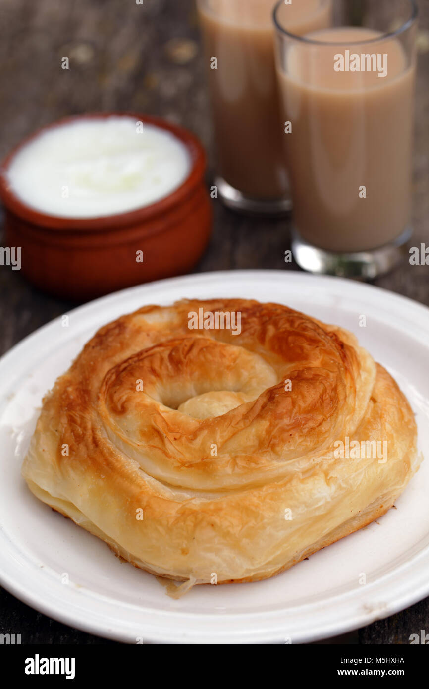 Traditional Bulgarian pastry Banitsa on a rustic table with Greek ...