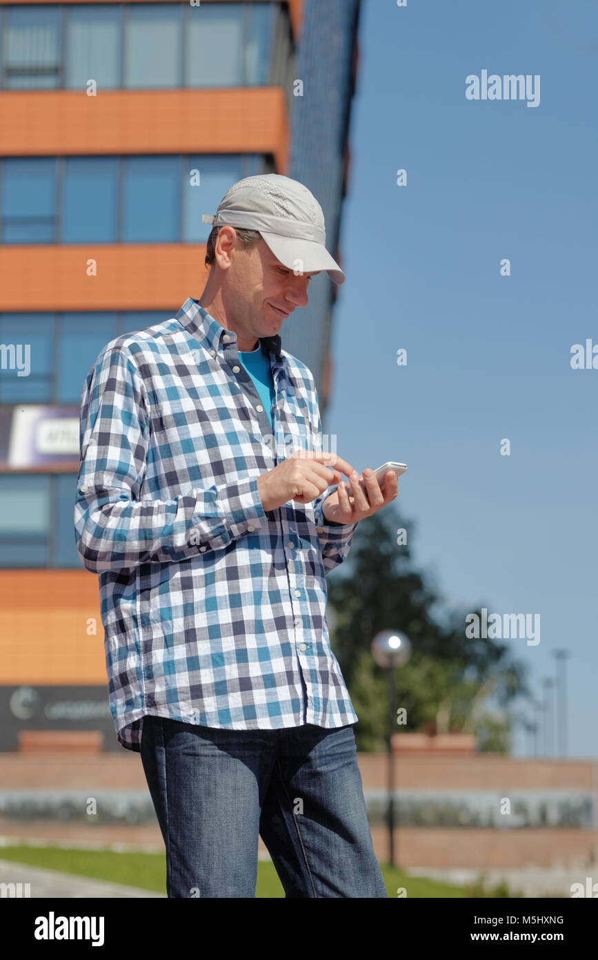 Mature man reading message on his smartphone Stock Photo - Alamy
