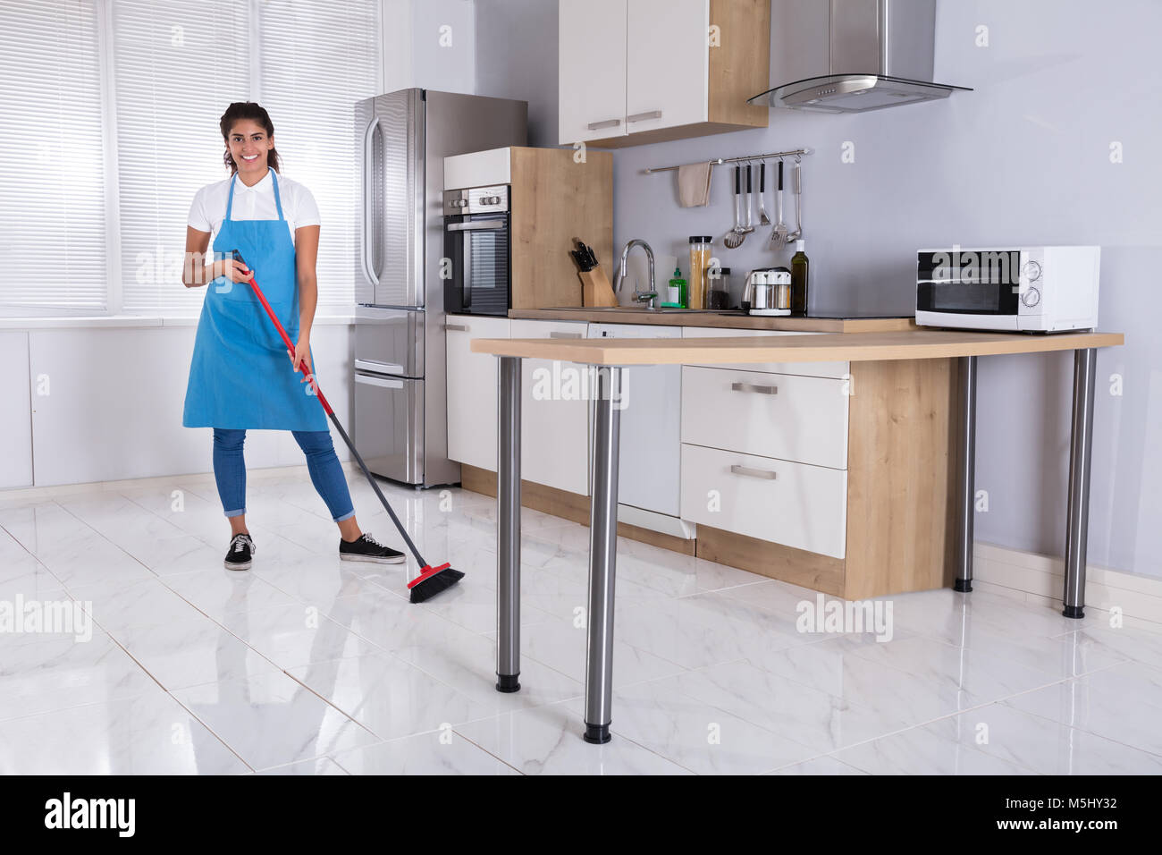 Woman sweeping broom hi-res stock photography and images - Alamy