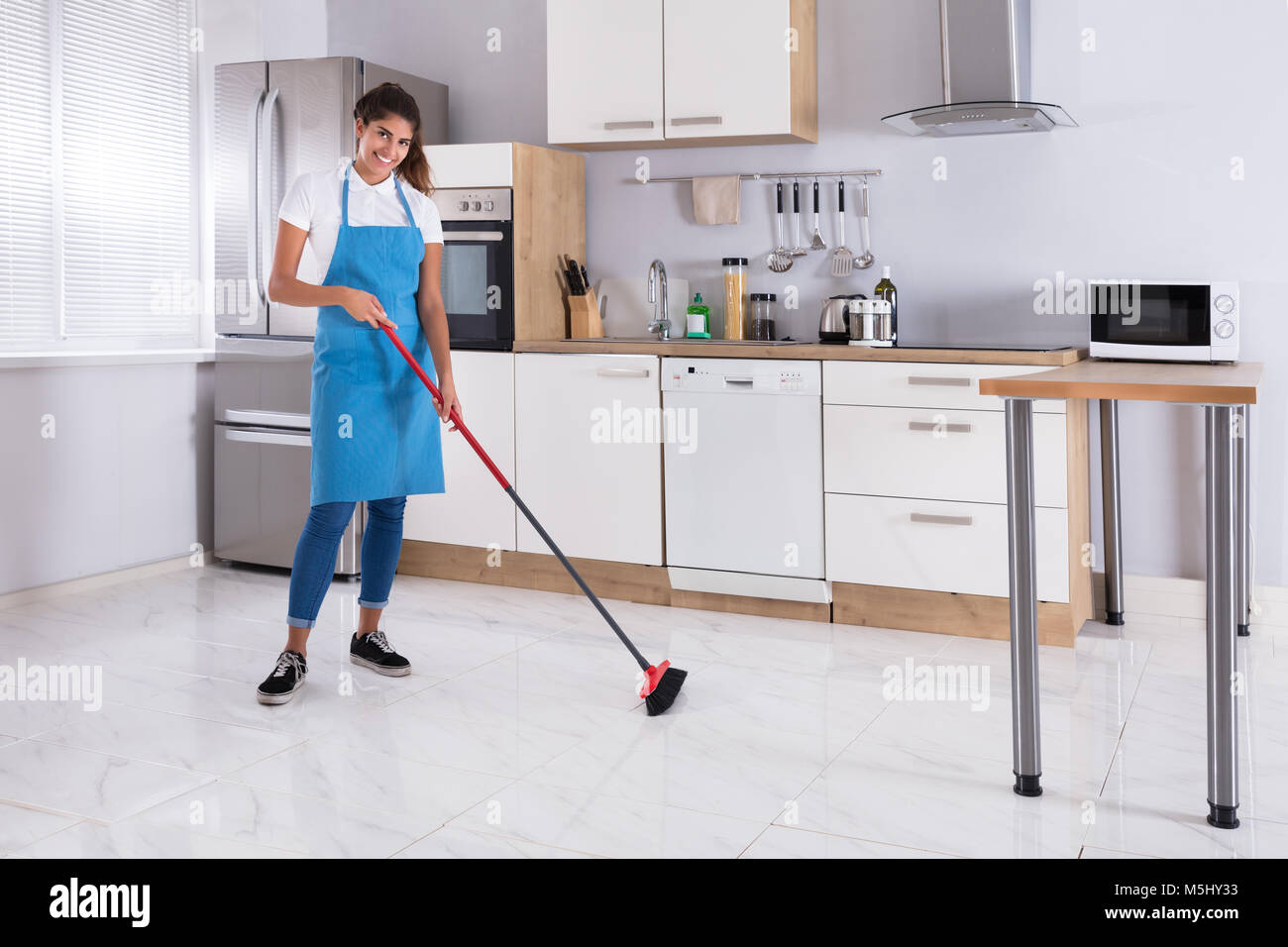 Woman sweeping broom hi-res stock photography and images - Alamy
