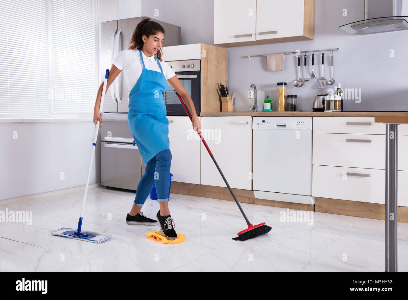 Woman multitasking cleaning hi-res stock photography and images - Alamy