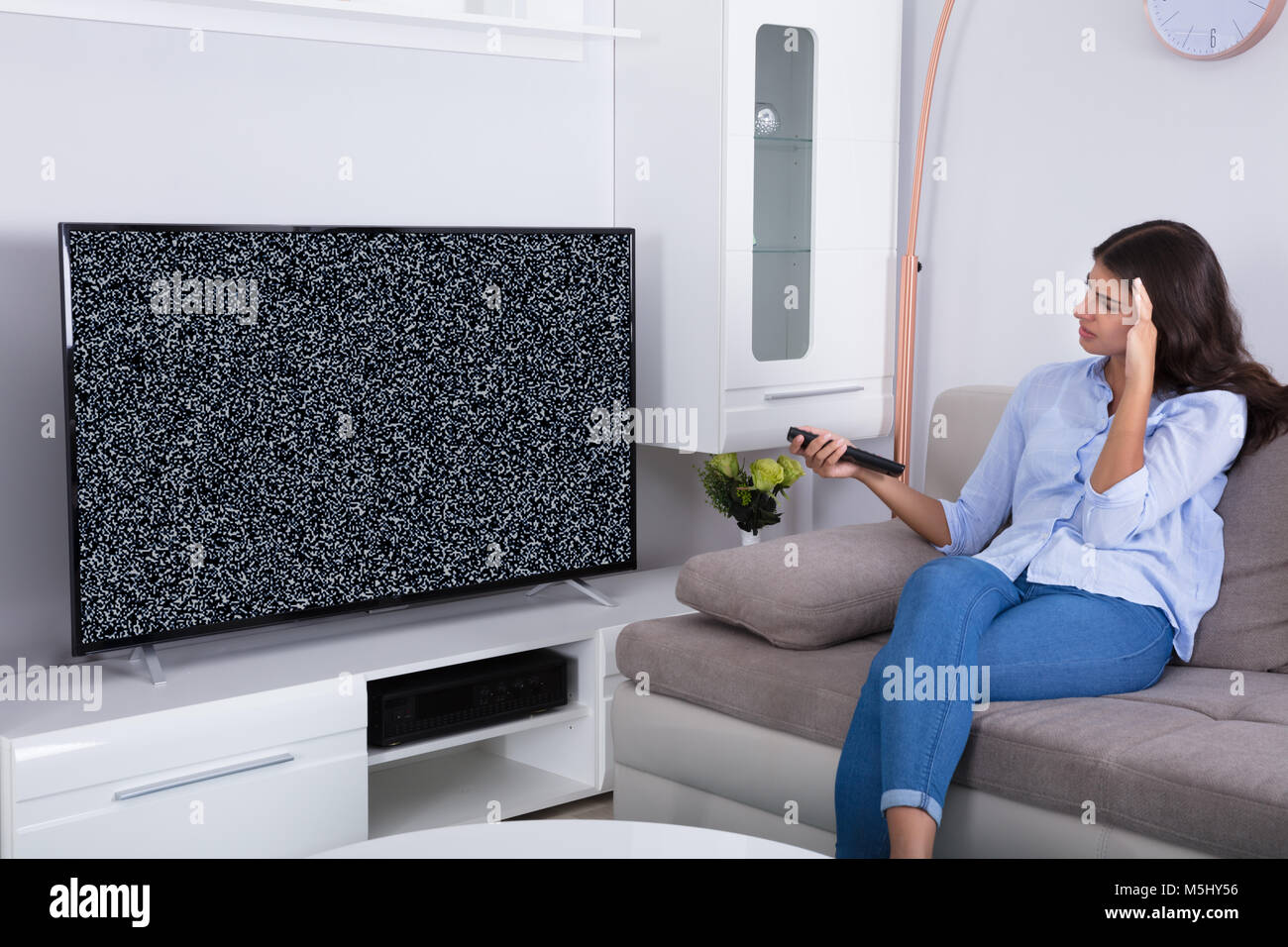 Woman sofa television with no signal hi-res stock photography and ...