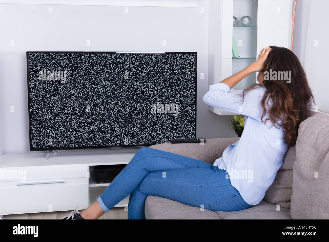 Woman sofa television with no signal hi-res stock photography and ...