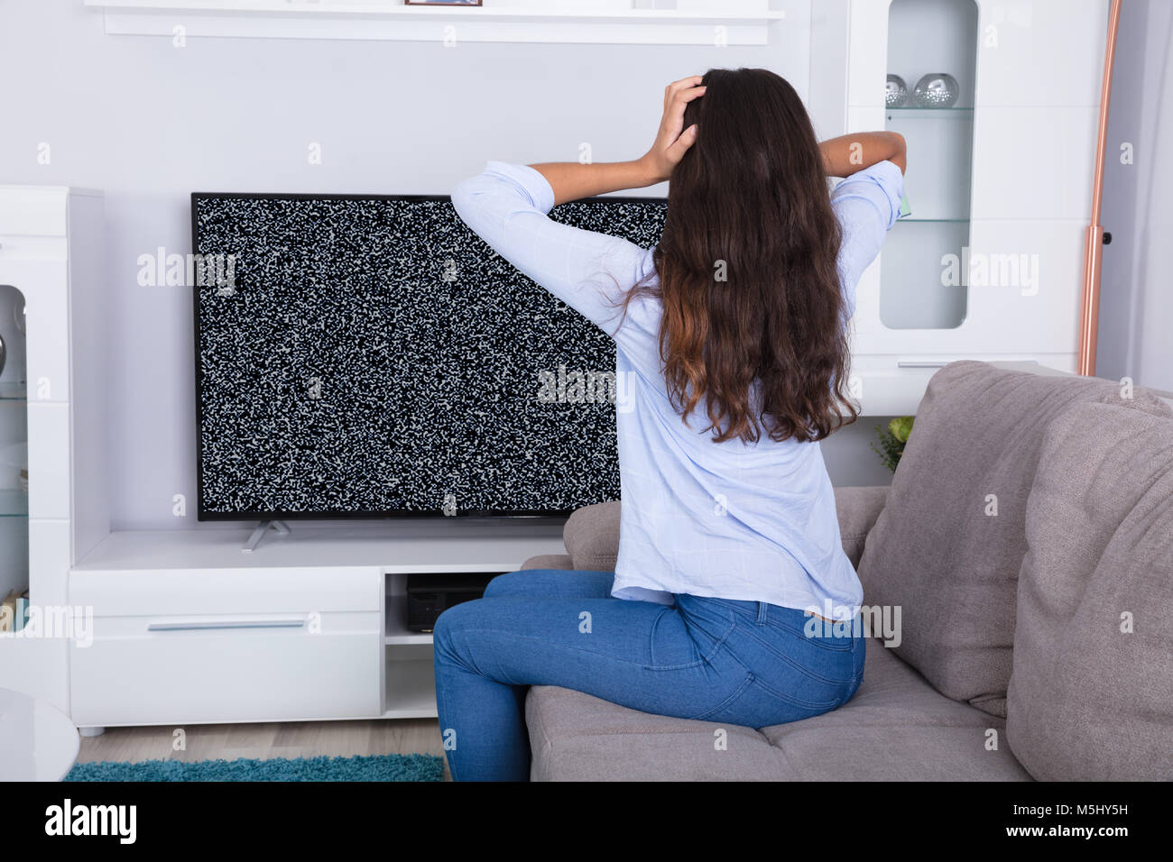 Woman sofa television with no signal hi-res stock photography and ...