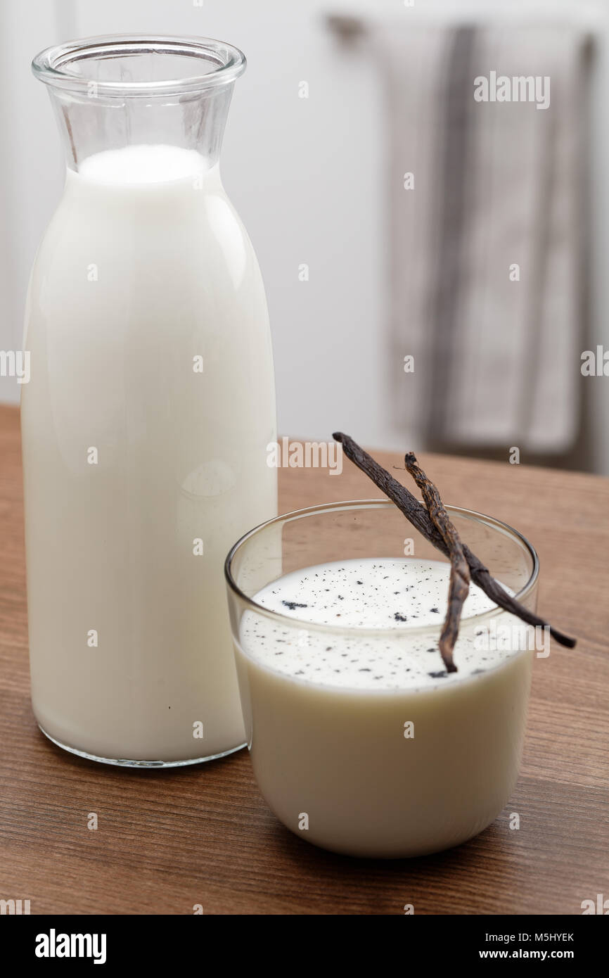 Vanilla milk on a kitchen table Stock Photo - Alamy