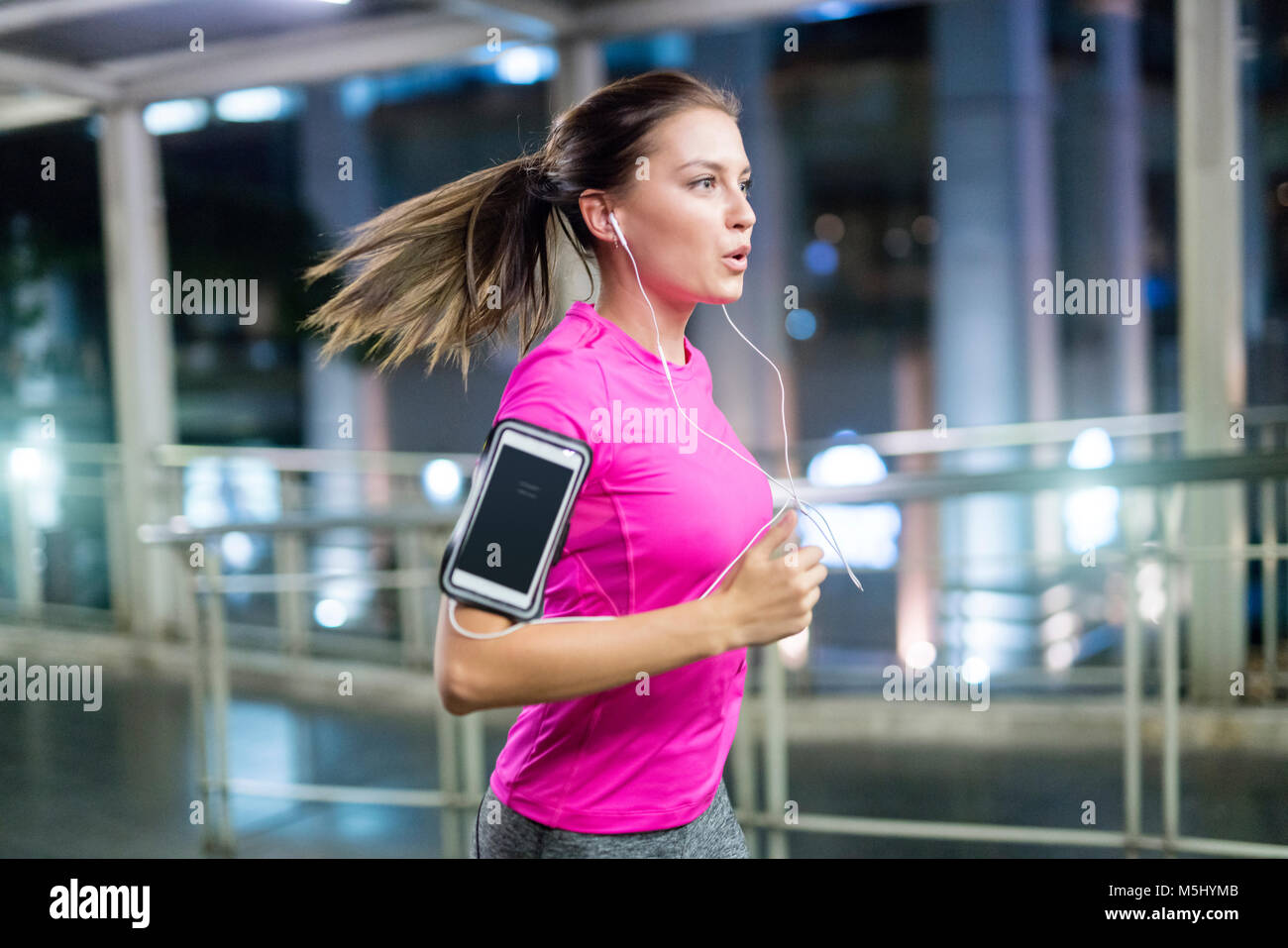 Woman running at night hi-res stock photography and images - Alamy