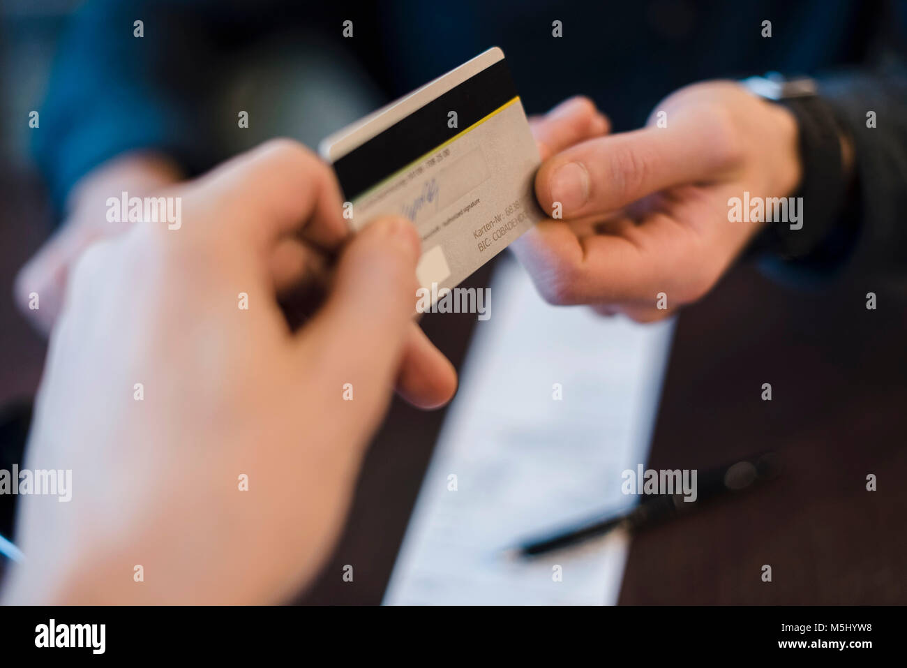 Customer paying with credit card, close-up Stock Photo - Alamy