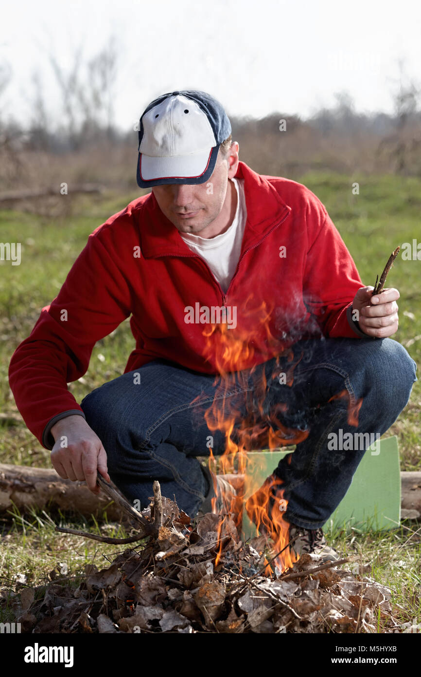 Man making fire during picnic Stock Photo - Alamy