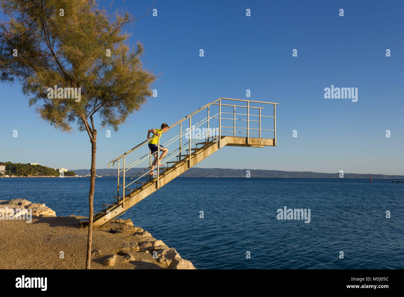 Boy on diving platform hi-res stock photography and images - Alamy