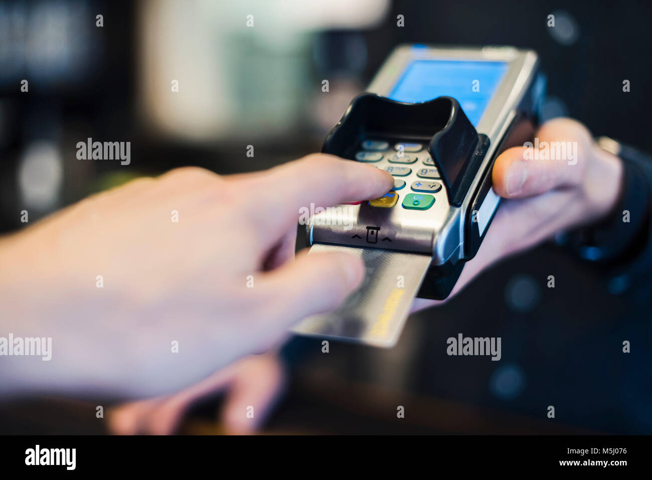 Man using credit card reader, close-up Stock Photo - Alamy