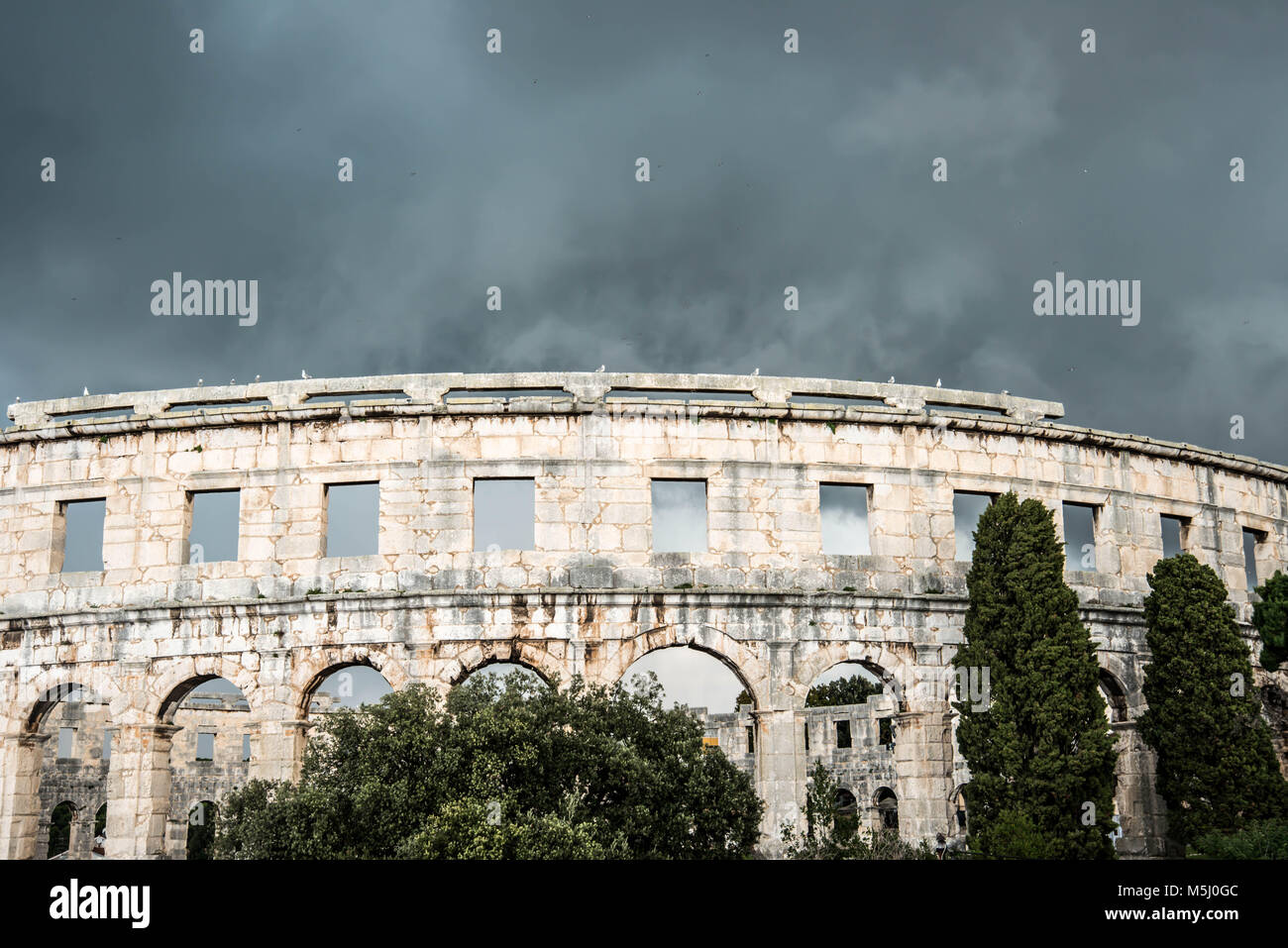 The ancient Roman Coliseum in Pula, Croatia against a stormy sky Stock ...