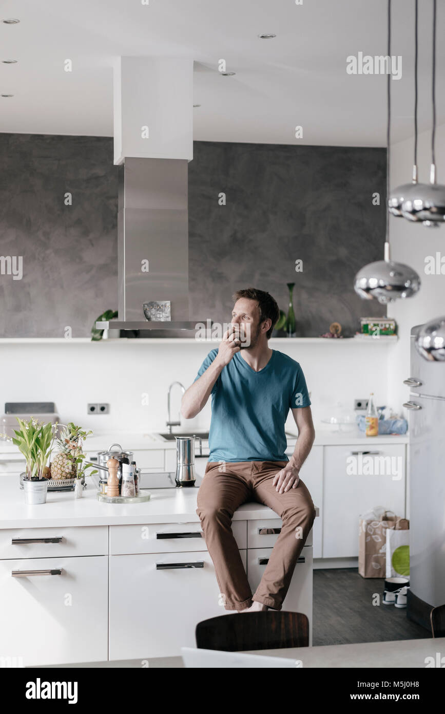 Mid adult man eating apple hi-res stock photography and images - Alamy