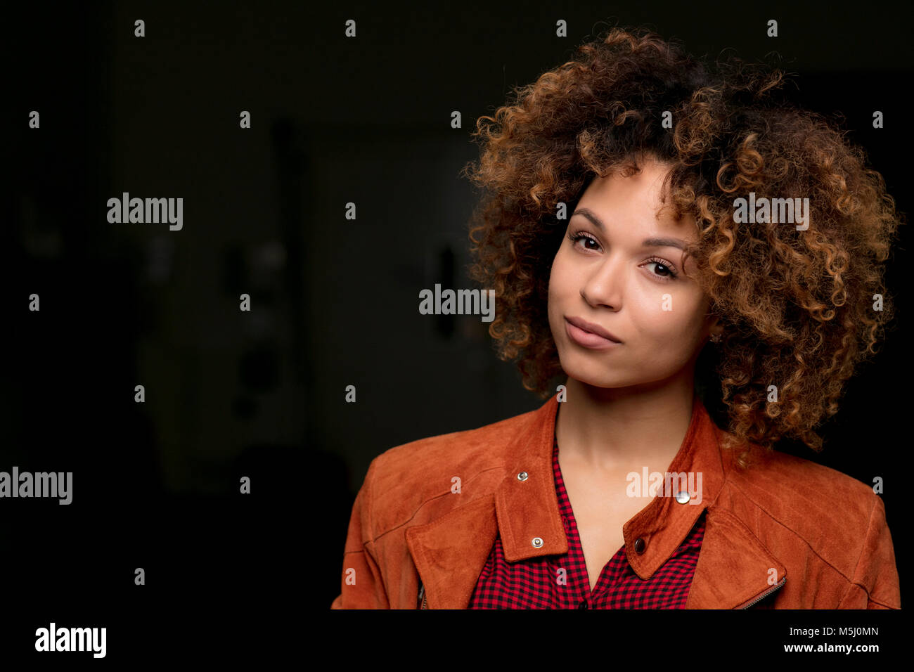 Portrait of woman with ringlets in front of black background Stock ...