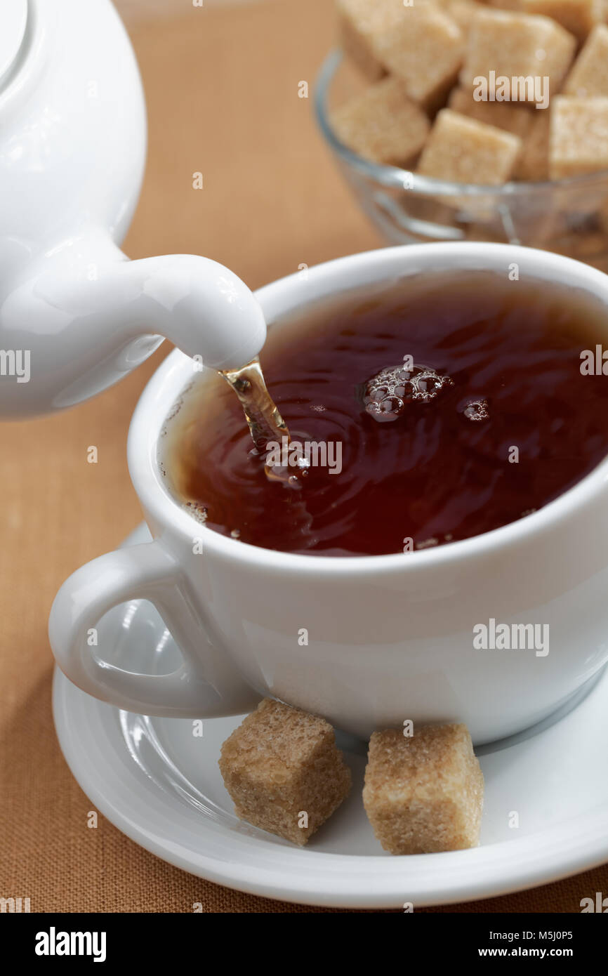 Pouring tea into a cup Stock Photo - Alamy