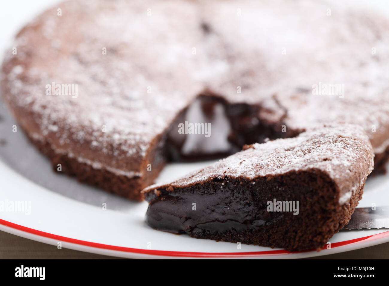 Slice of chocolate mud cake closeup Stock Photo - Alamy