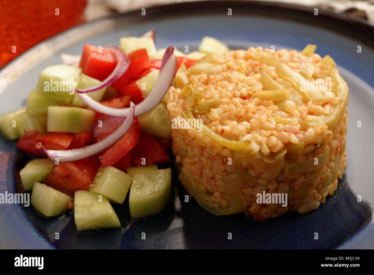 Pilaf with pepper and vegetable salad Stock Photo - Alamy