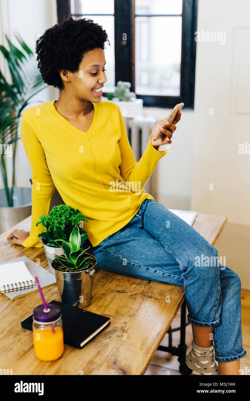 Young woman at home using smartphone Stock Photo - Alamy