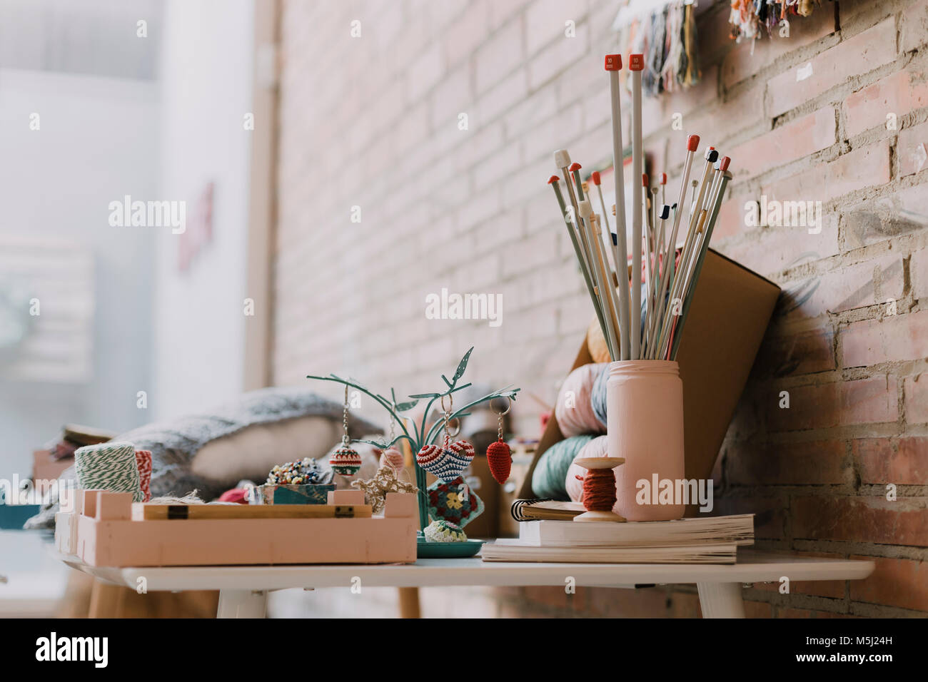 Knitting utensils on table Stock Photo - Alamy