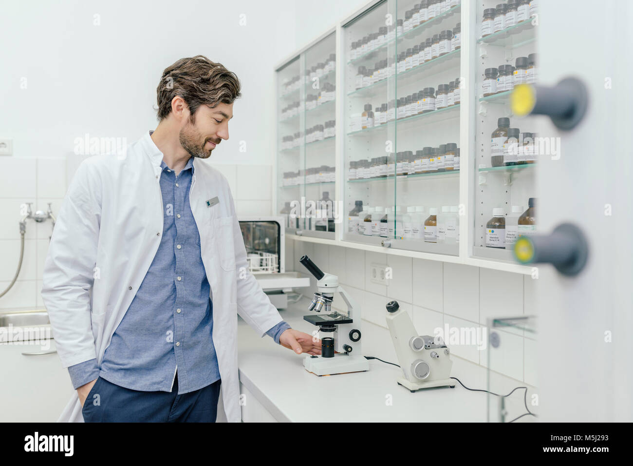 Man in laboratory with microscope hi-res stock photography and images ...