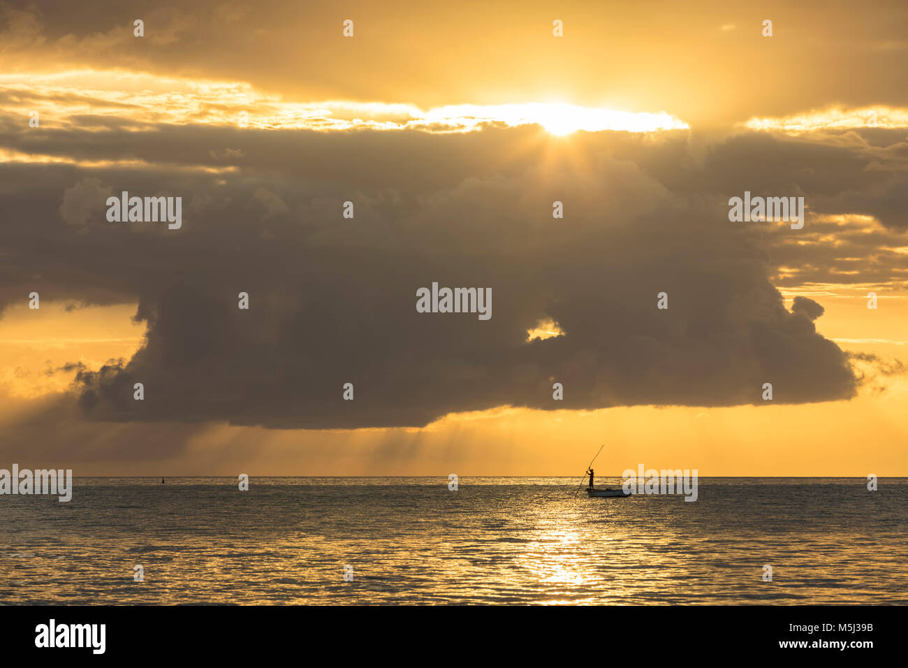 Mauritius, West Coast, Riviere Noire, Fisherman at sunset Stock Photo ...