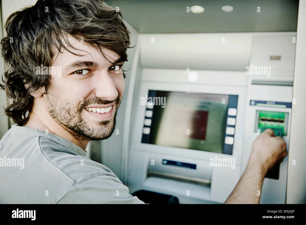 Using the cash machine hi-res stock photography and images - Alamy