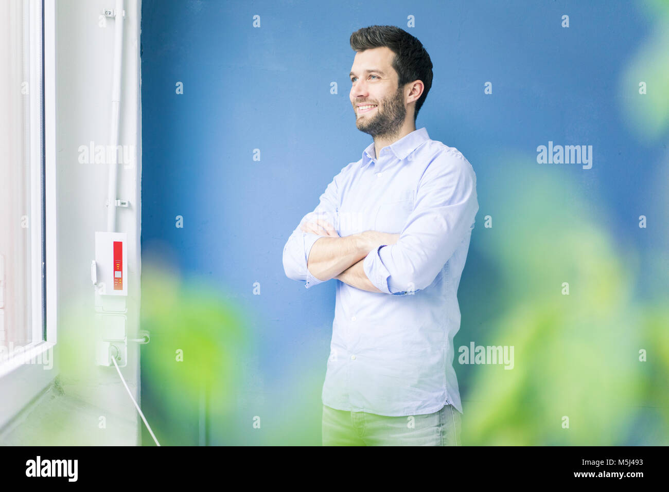 Freelancer man standing window hi-res stock photography and images - Alamy