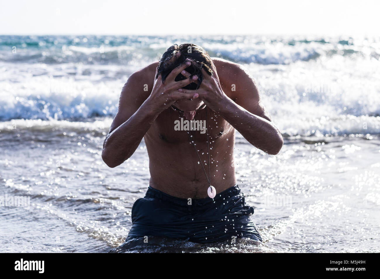 Young man bathing in the sea Stock Photo - Alamy