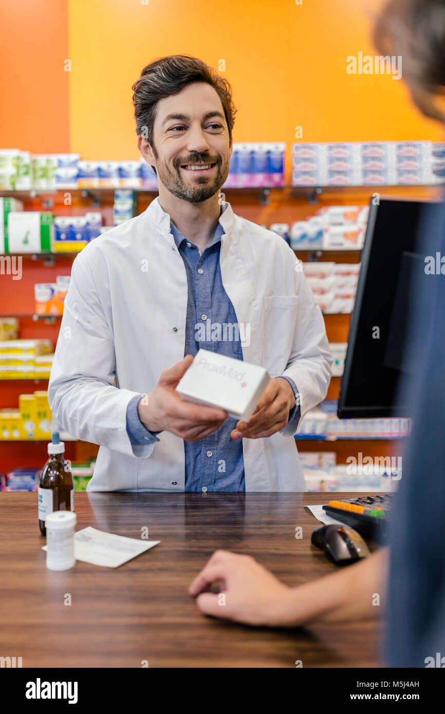 Pharmacist explaining medicine to customer in pharmacy Stock Photo - Alamy