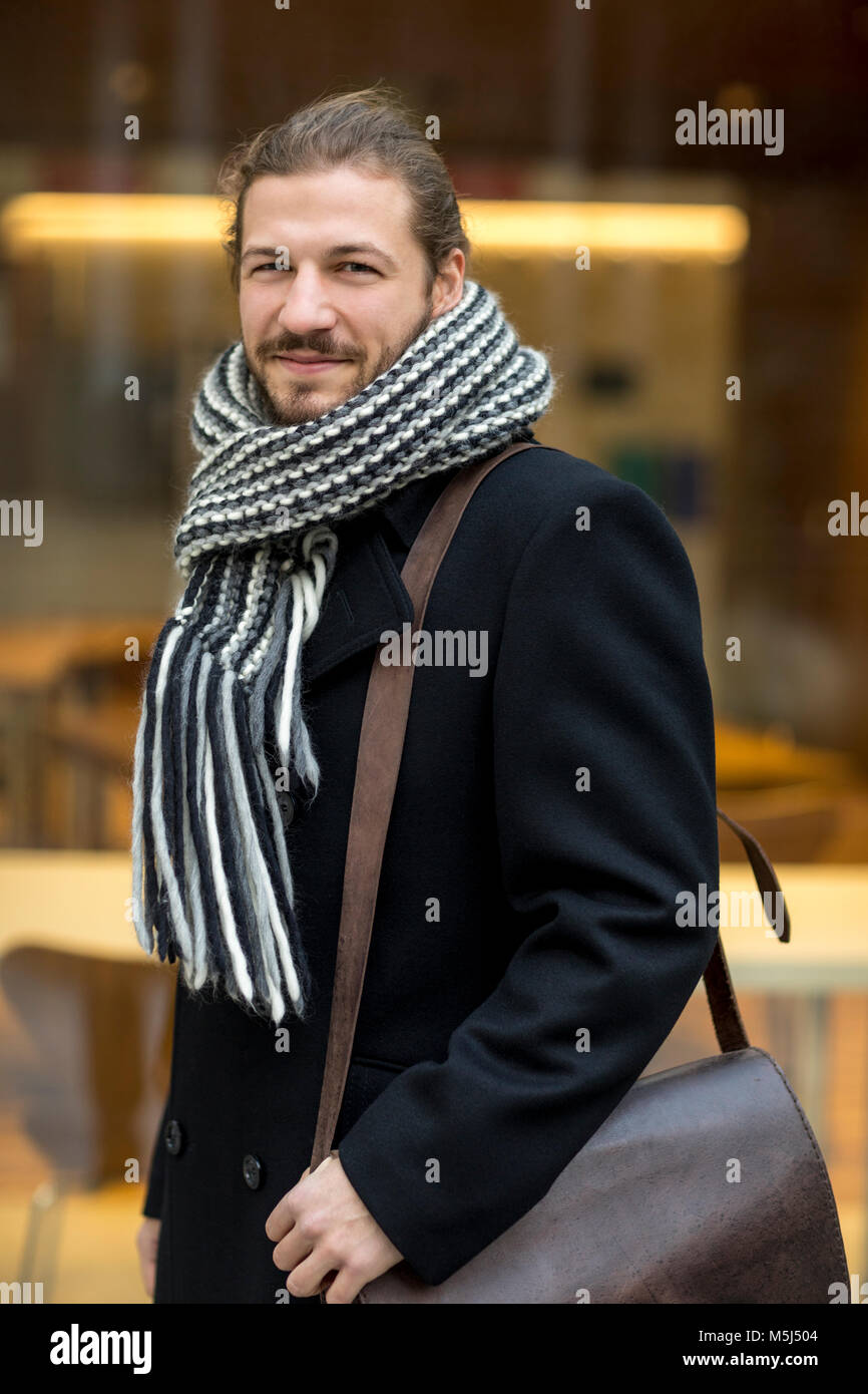 Young man wearing coat scarf hi-res stock photography and images - Alamy