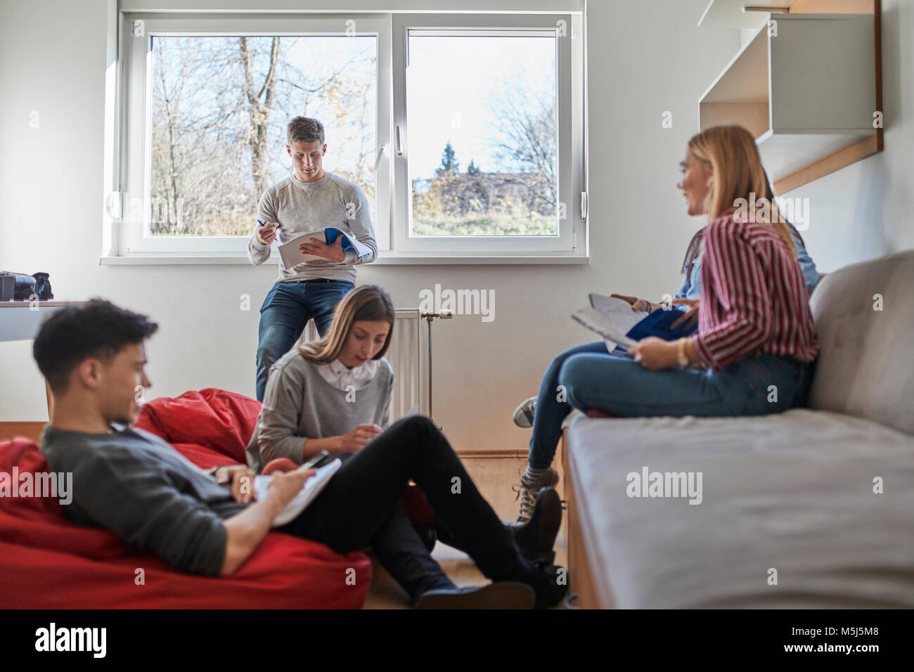 Group of students in dormitory learning together Stock Photo - Alamy