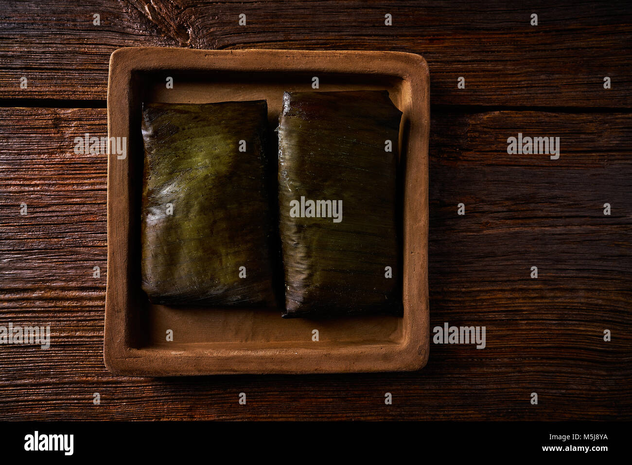 Tamale Mexican food recipe with banana leaves steamed Stock Photo - Alamy