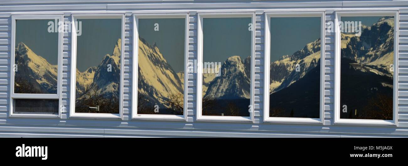 A stunning window reflection, with amazing snow covered mountains in ...