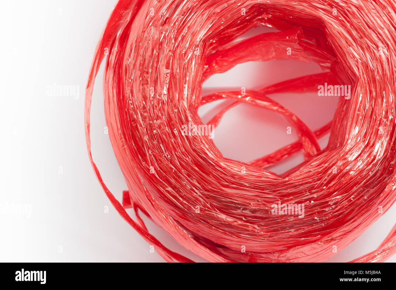 Close up Red plastic rope top view on white background Stock Photo - Alamy