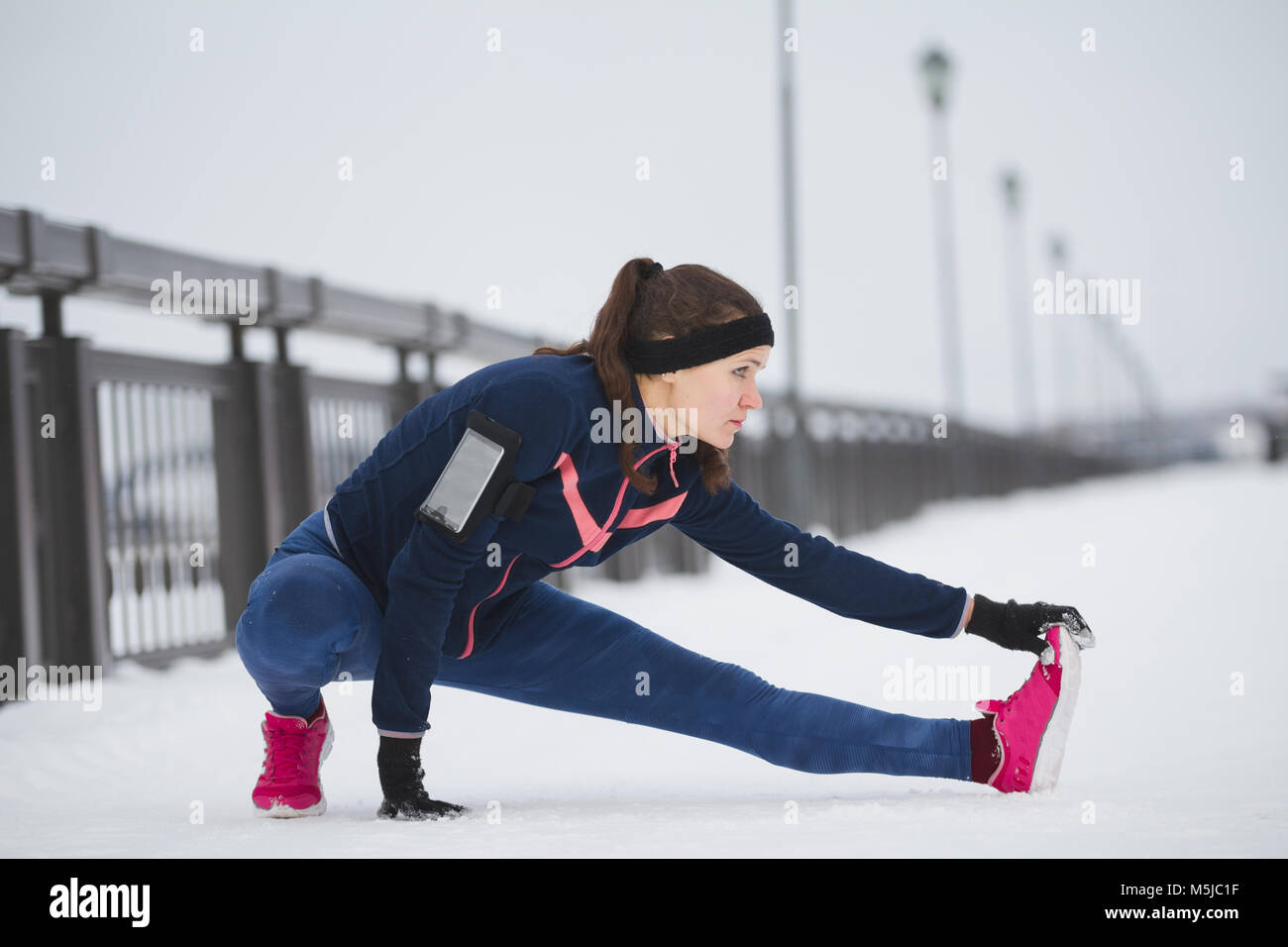 Woman runner stretching legs before run. Young athlete woman working out. Fitness concept Stock ...