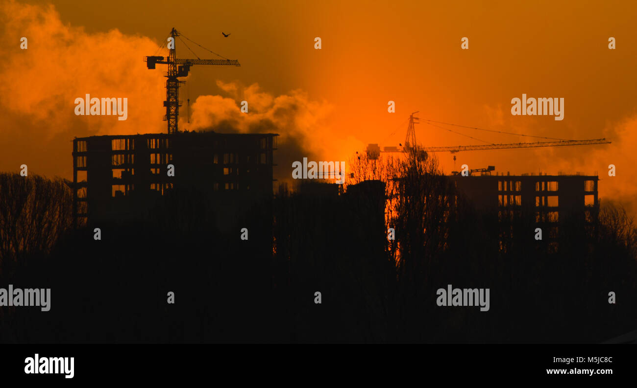 House under construction in foggy evaporation at sunset, background ...