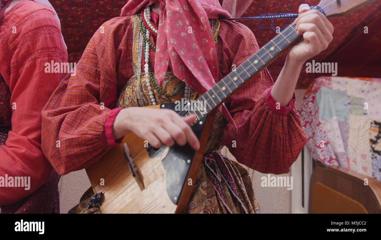 Woman playing balalaika hi-res stock photography and images - Alamy