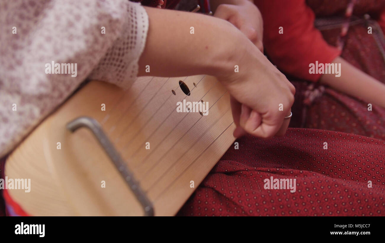 Gusli - woman in Russian folk costume playing vintage musical ...