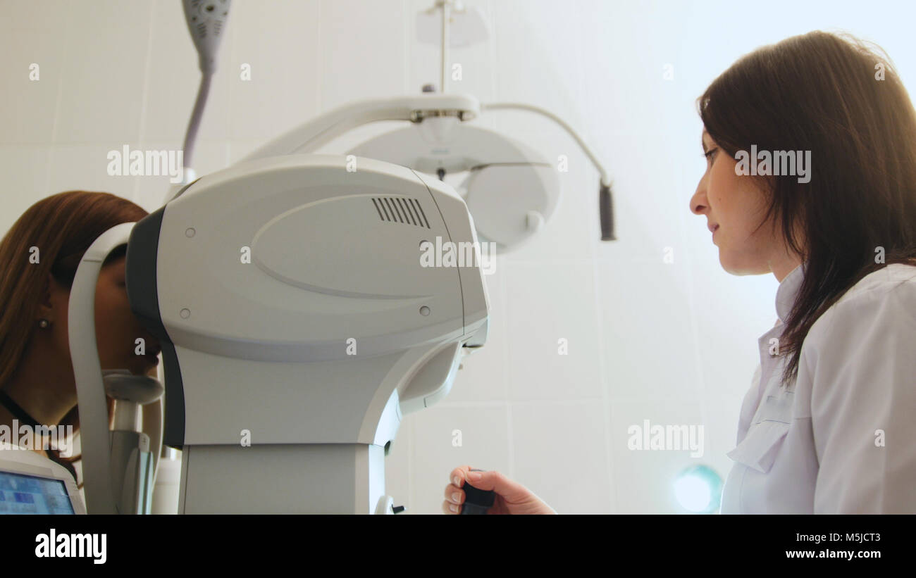 Ophthalmologist in eyes clinic doing diagnostic with vision for patient ...