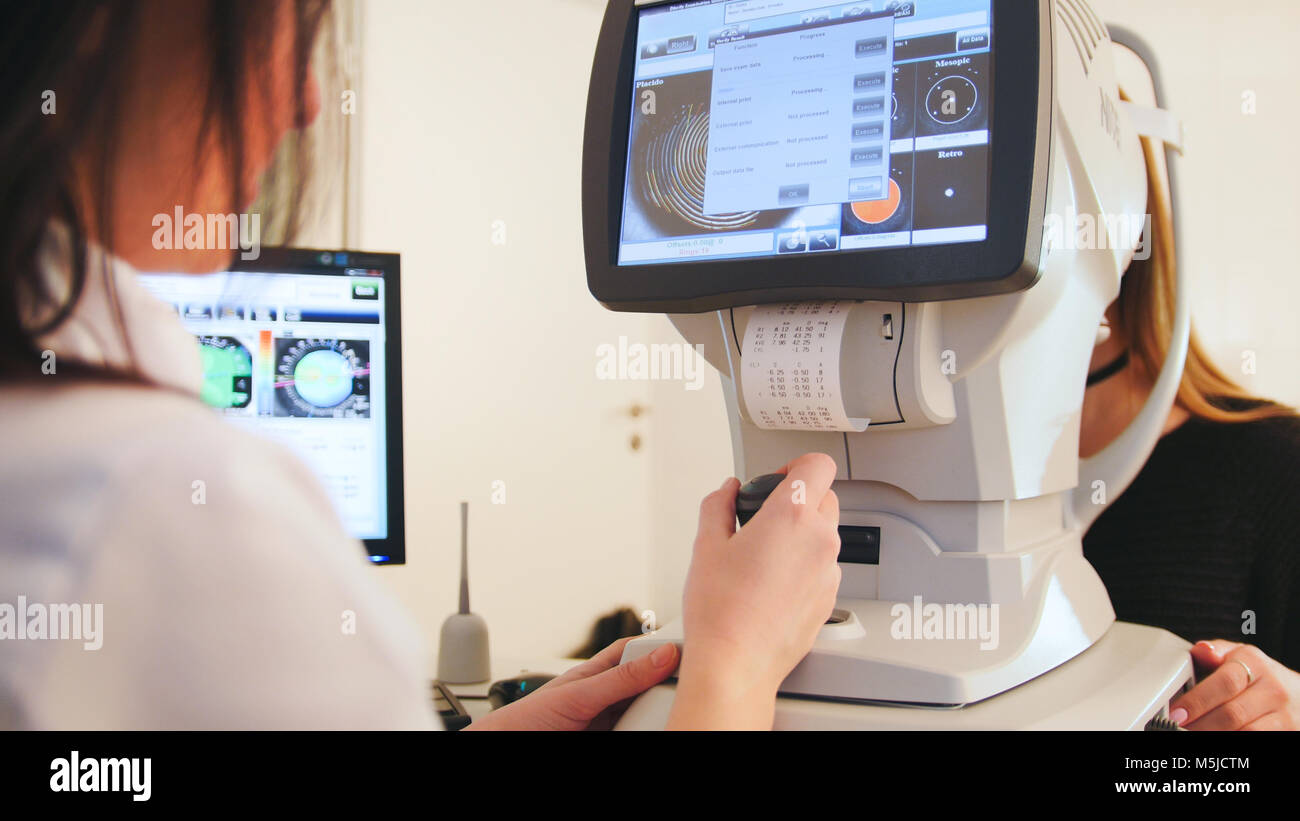 Ophthalmologist in eyes clinic doing diagnostic with vision of patient ...