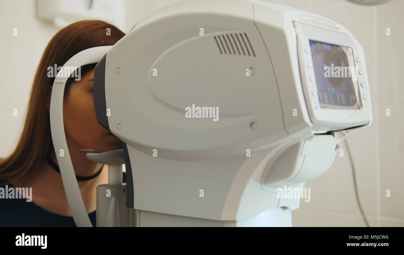 Ophthalmology clinic concept - patient doing checking vision by modern ...