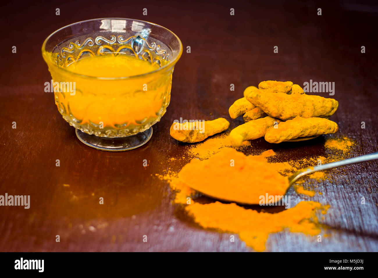 Tea of turmeric,Curcuma longa with its powder Stock Photo - Alamy