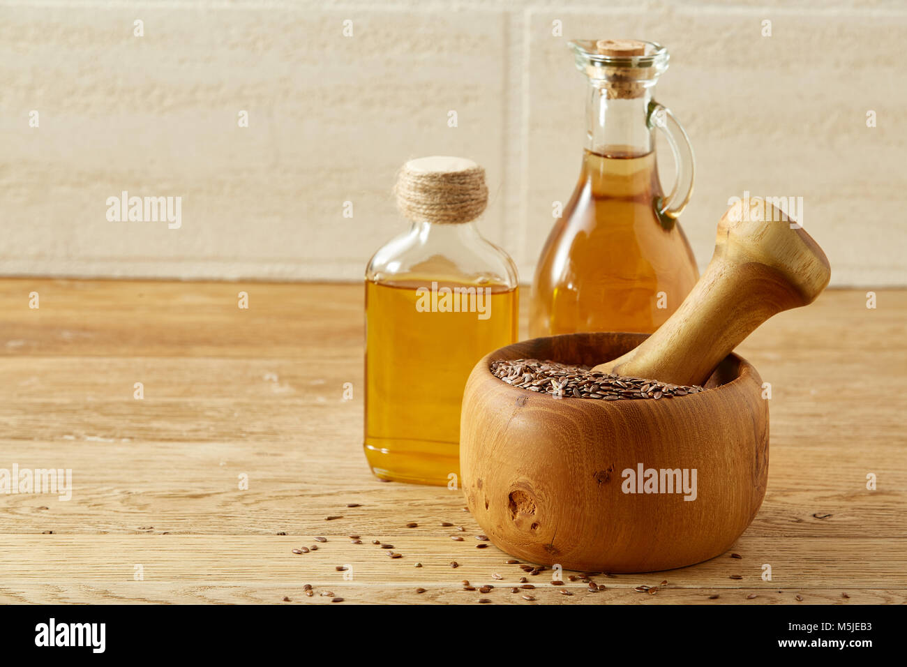 Beautiful composition of two transparent glass oil jars, wooden mortar ...