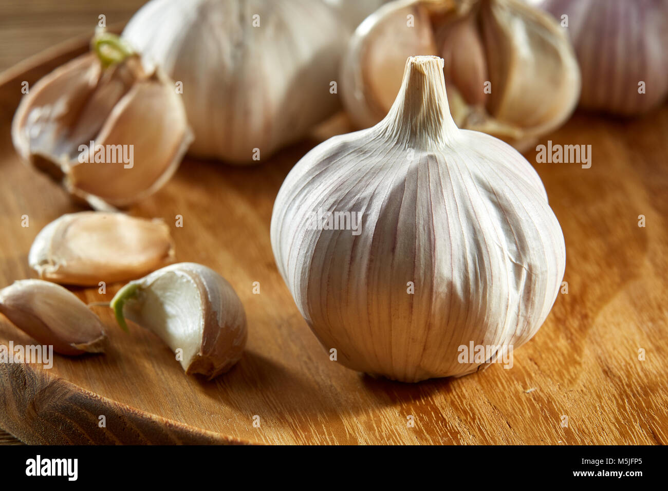 Garlic on rustic rough wooden background. Close-up, shallow depth of ...