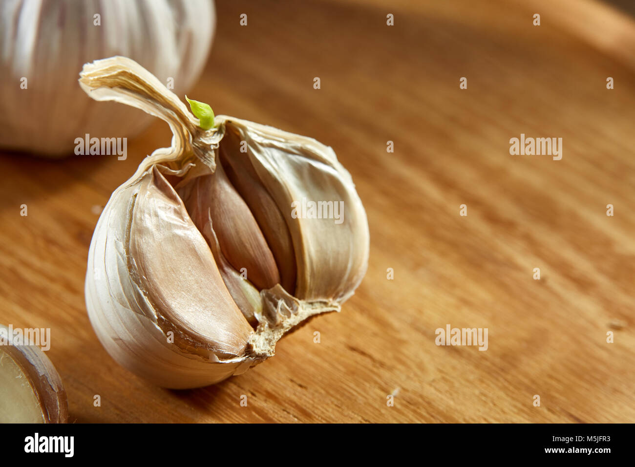 Garlic on rustic rough wooden background. Close-up, shallow depth of ...