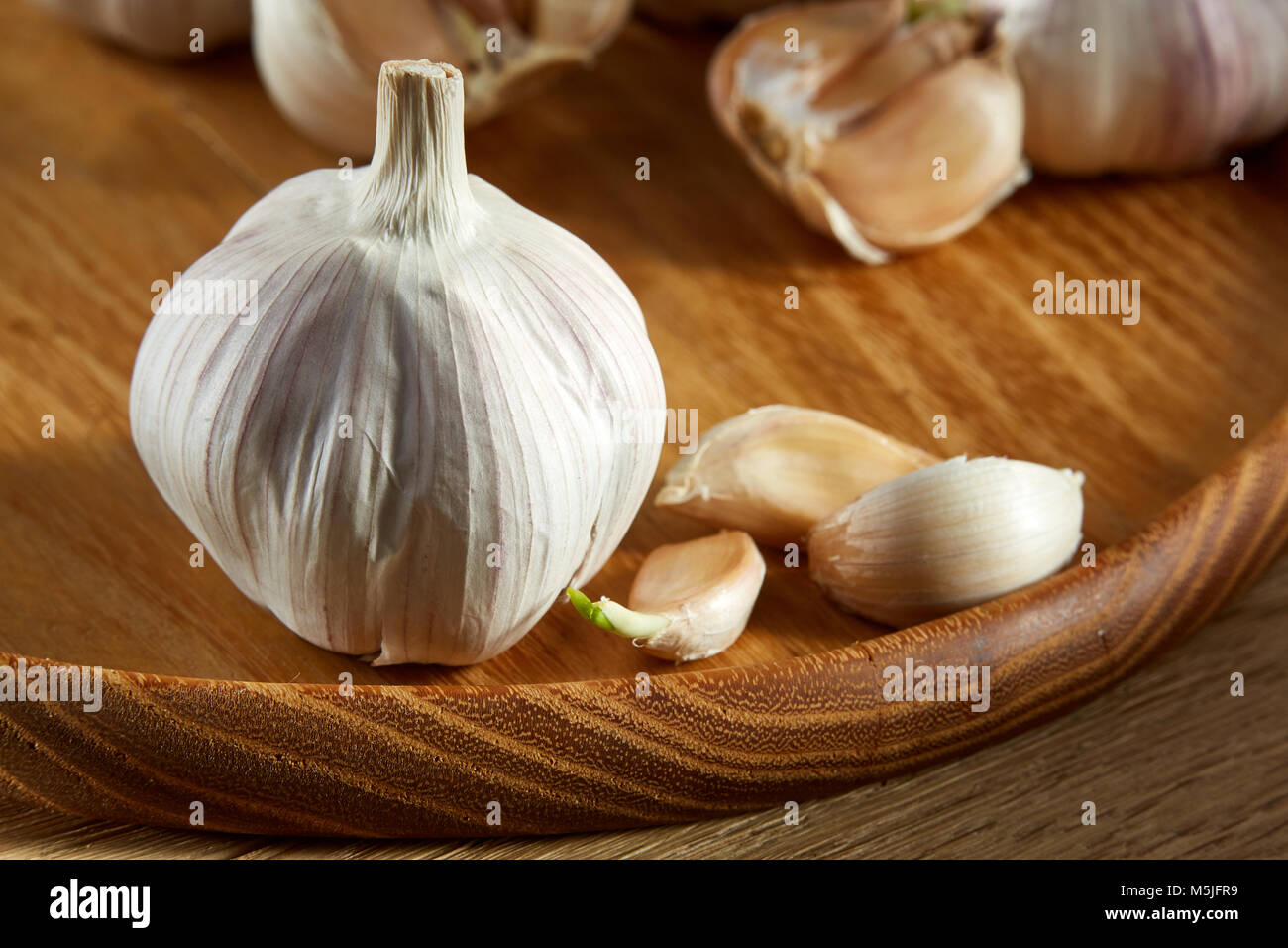 Garlic on rustic rough wooden background. Close-up, shallow depth of ...