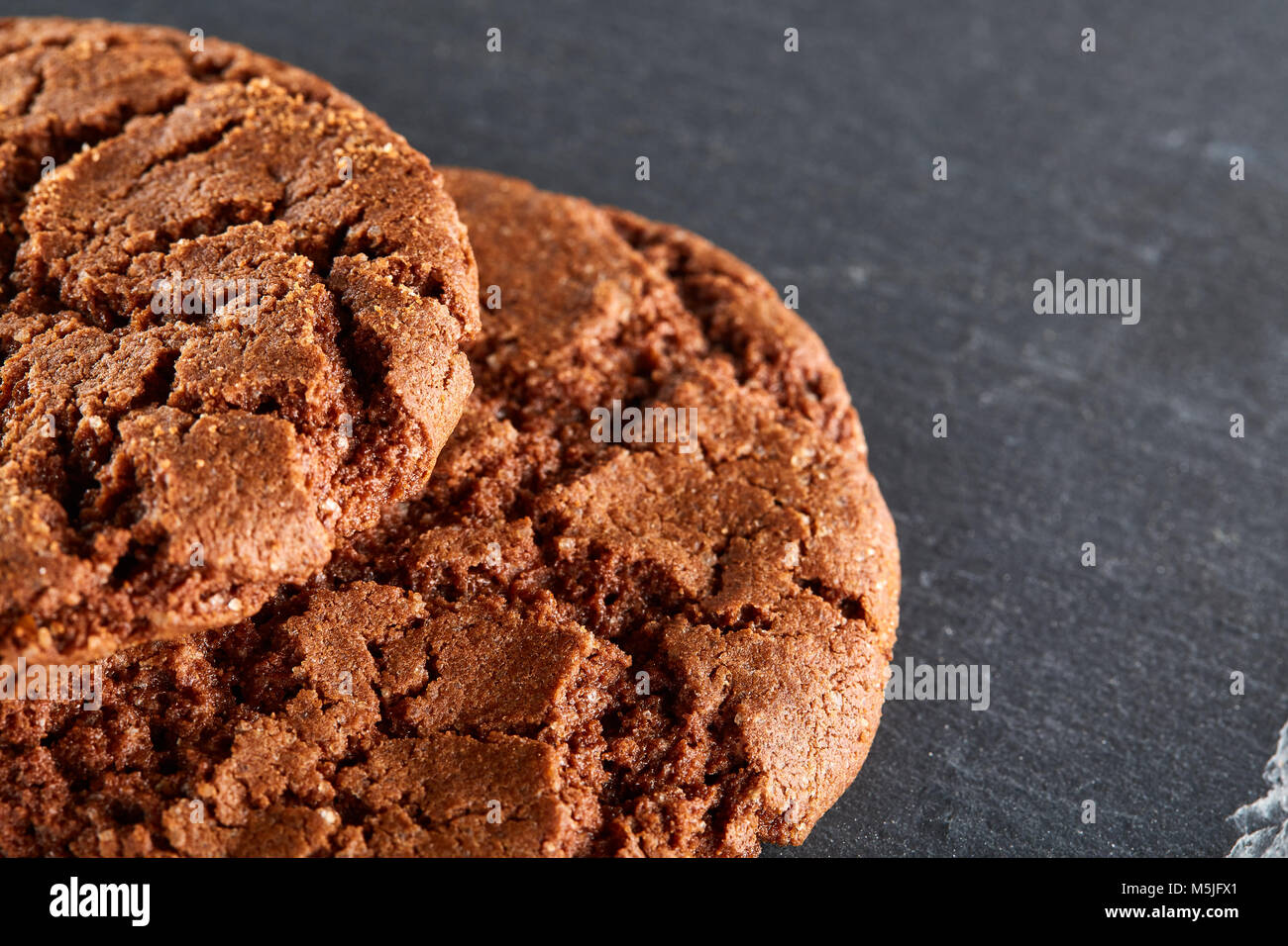 Close-up picture of chocolate cookies on dark background, shallow depth ...